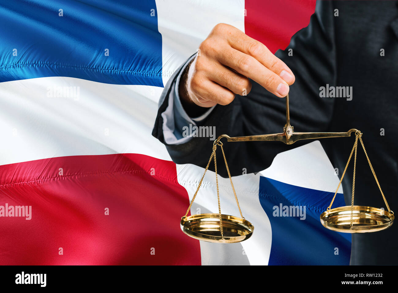 Dominican Judge is holding golden scales of justice with Dominican ...