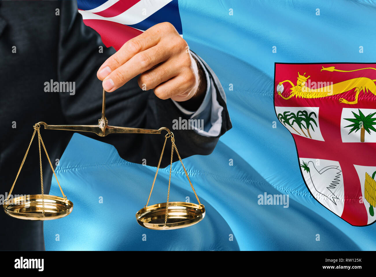 Fijian Judge is holding golden scales of justice with Fiji waving flag ...