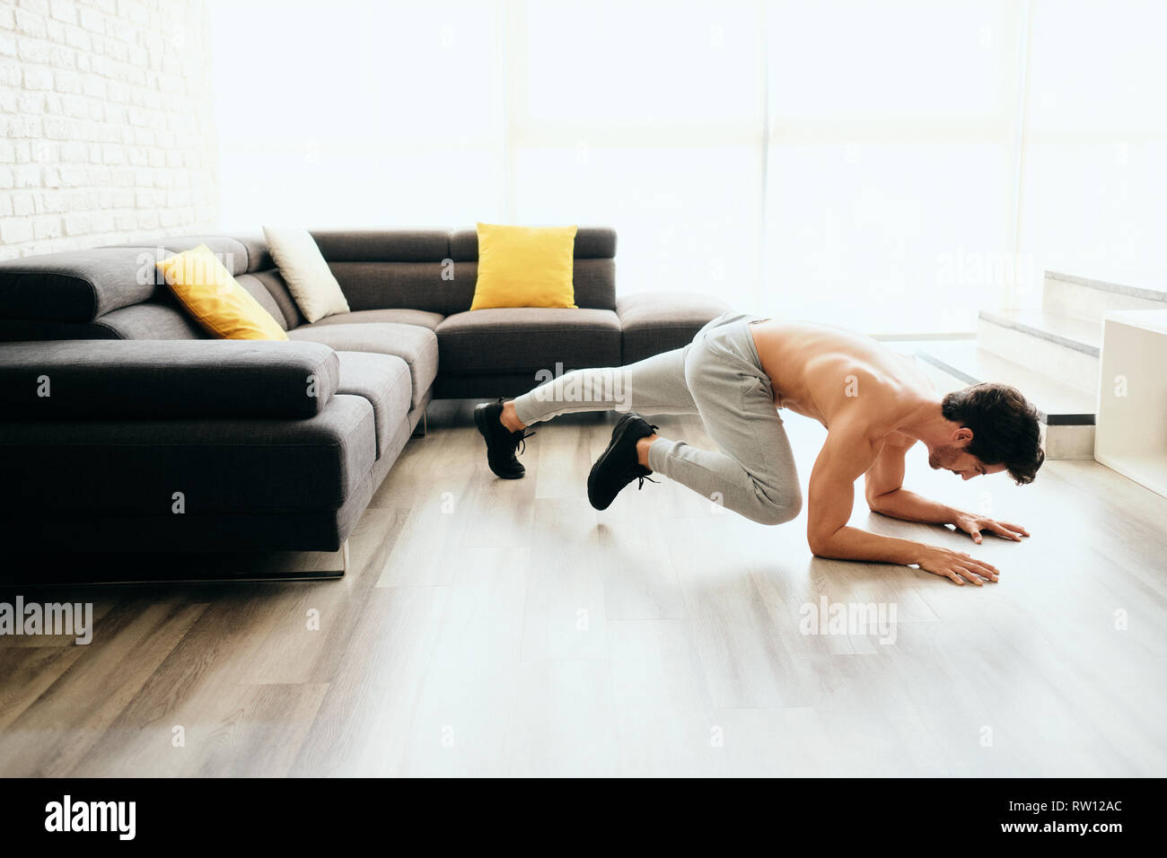 Fit young white man training at home. Handsome hispanic male athlete ...