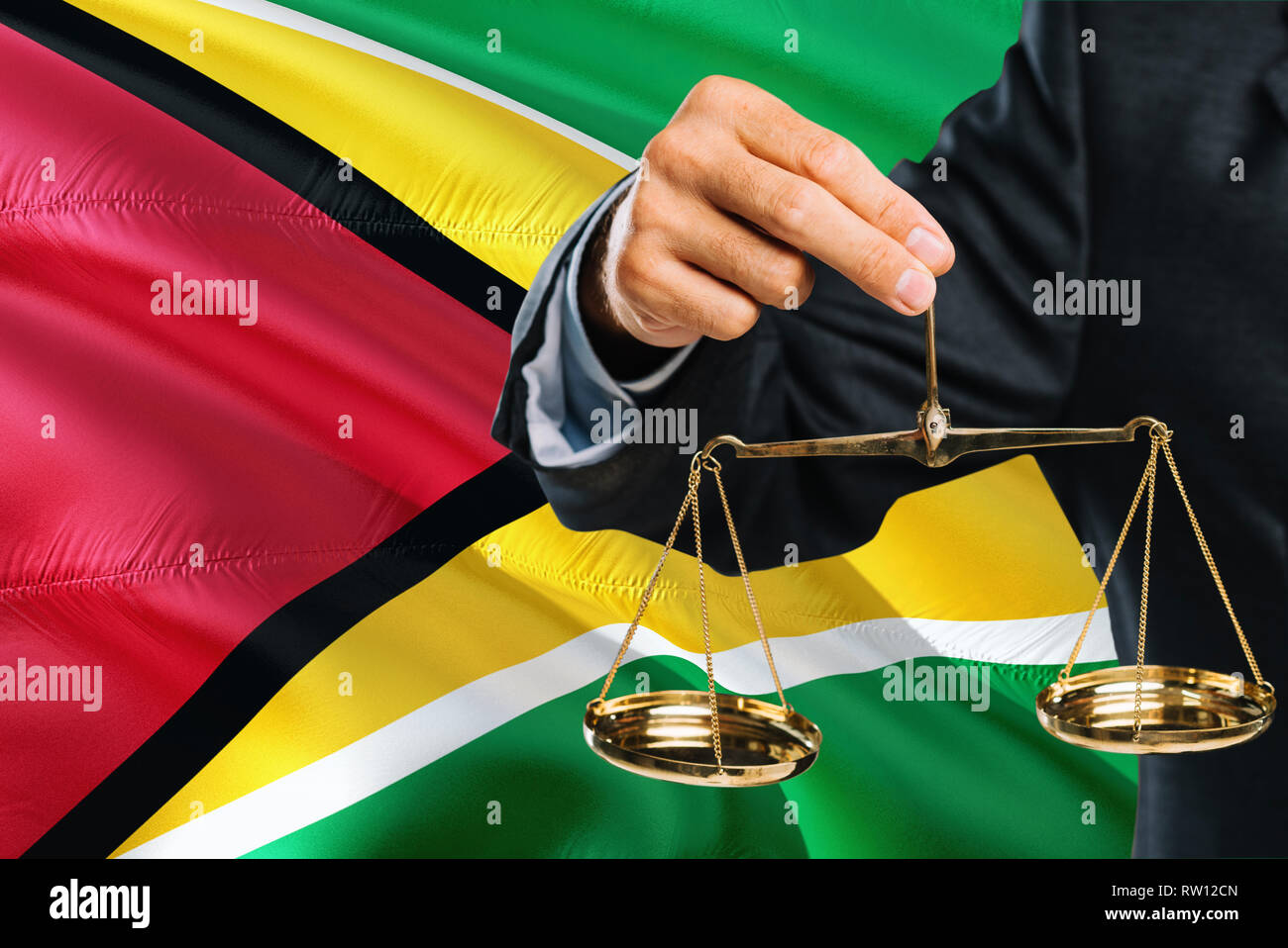 Guyanese Judge is holding golden scales of justice with Guyana waving ...