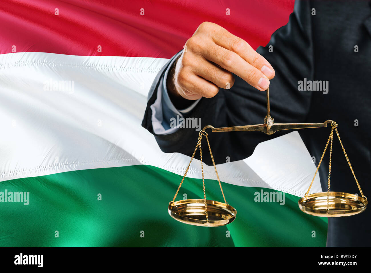 Hungarian Judge is holding golden scales of justice with Hungary waving ...
