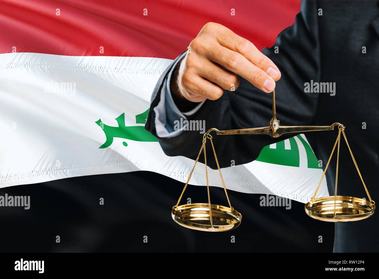 Iraqi Judge is holding golden scales of justice with Iraq waving flag ...