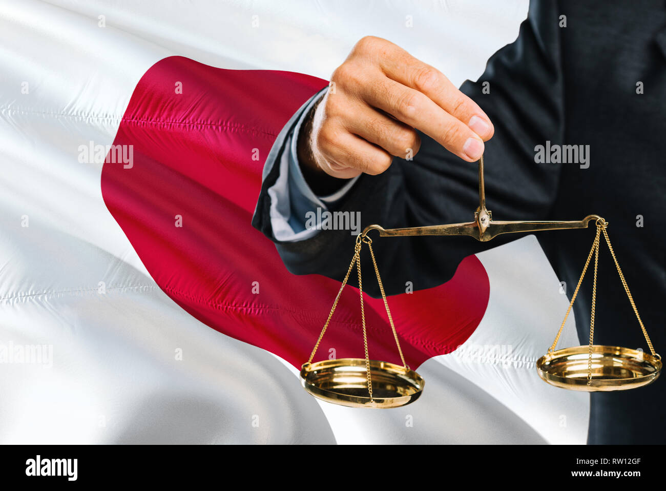 Japanese Judge is holding golden scales of justice with Japan waving ...