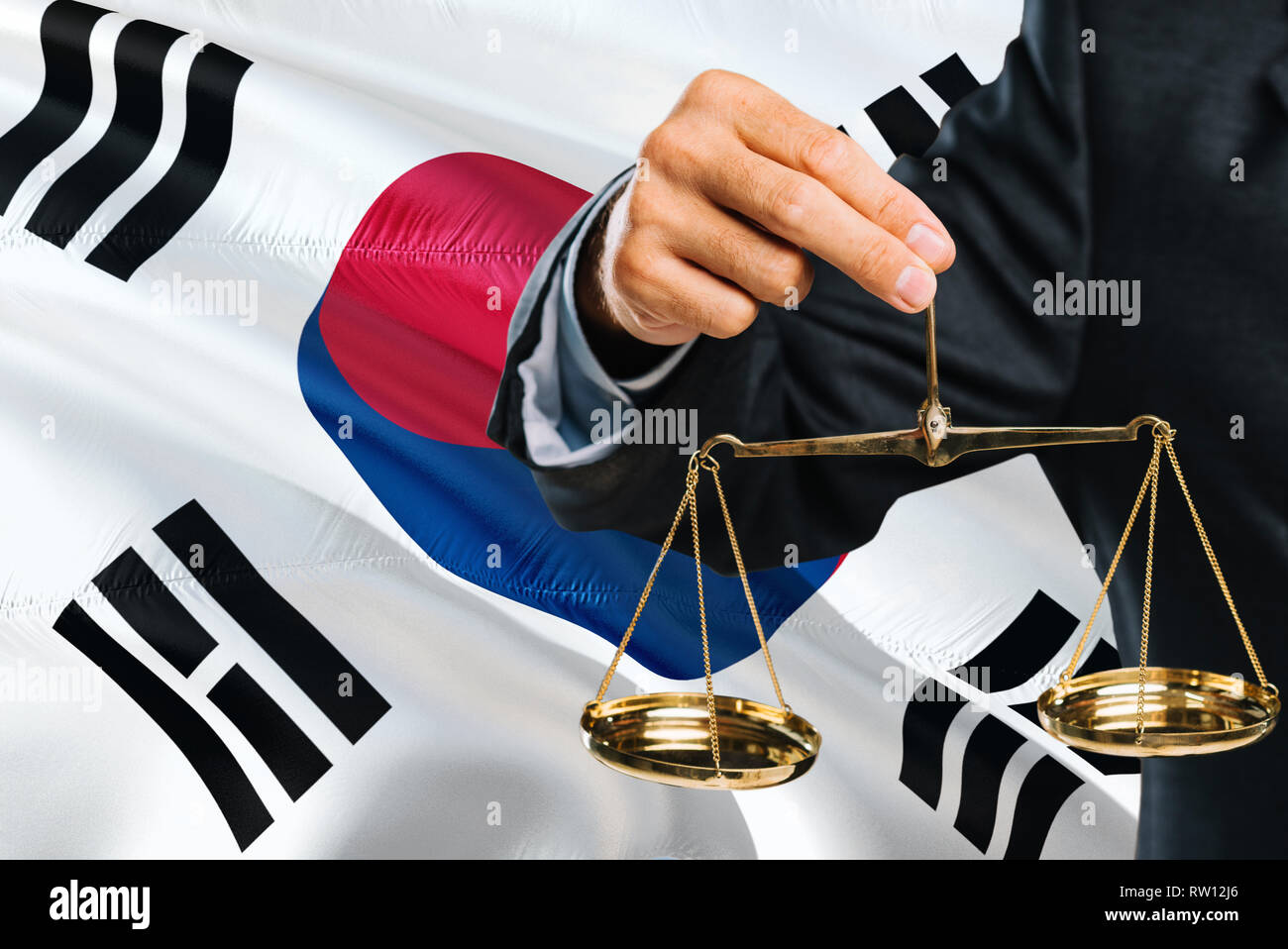 South Korean Judge is holding golden scales of justice with South Korea ...