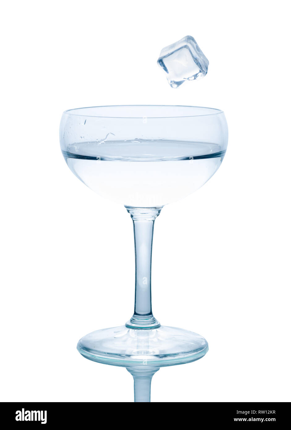 ice cube drop in a wine glass of water, isolated on the white ...