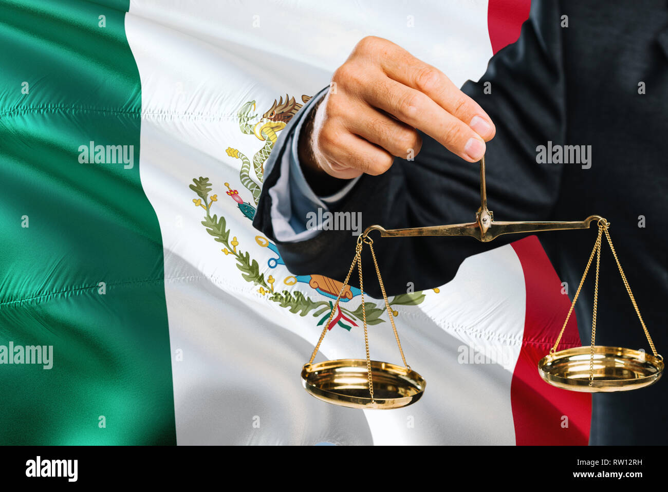Mexican Judge is holding golden scales of justice with Mexico waving ...