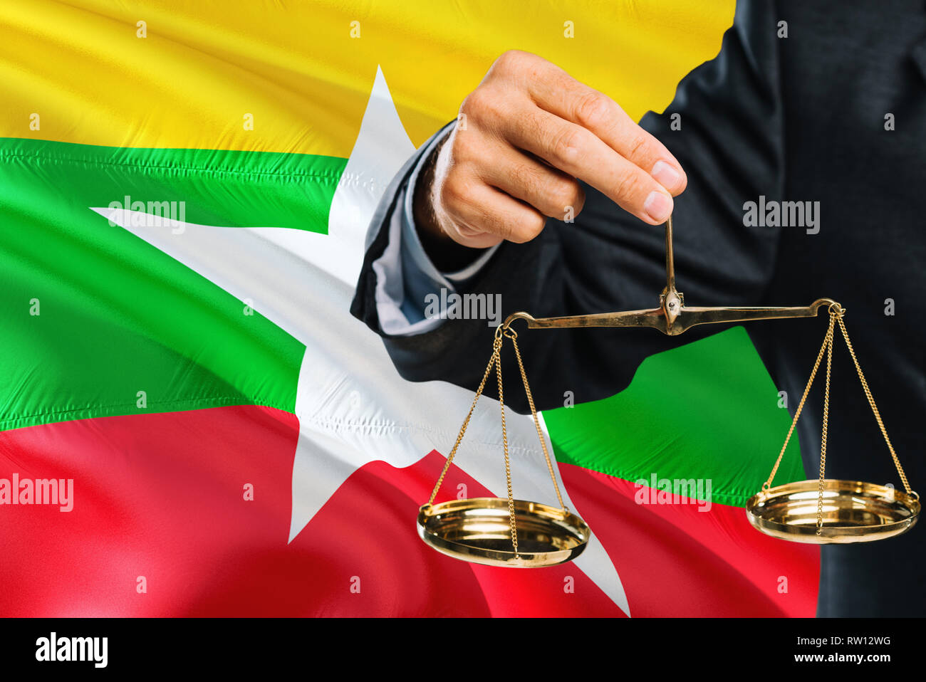 Burmese Judge is holding golden scales of justice with Myanmar waving ...