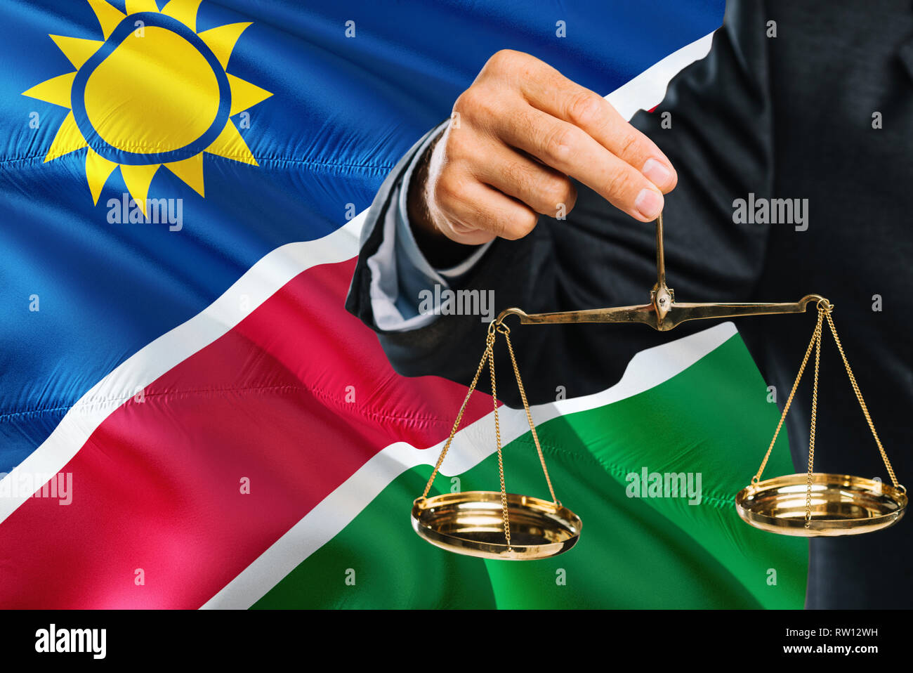 Namibian Judge is holding golden scales of justice with Namibia waving ...