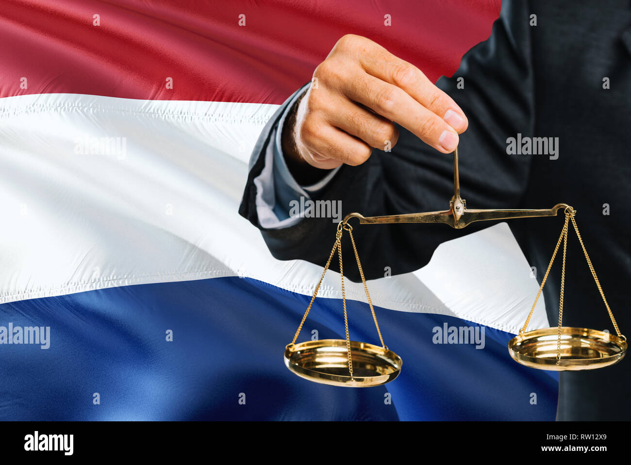 Dutch Judge is holding golden scales of justice with Netherlands waving ...