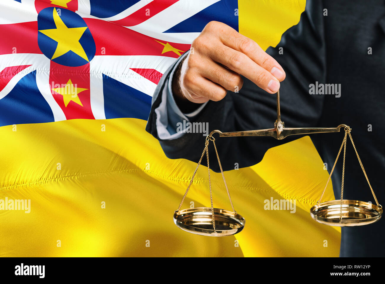 Judge Is Holding Golden Scales Of Justice With Niue Waving Flag