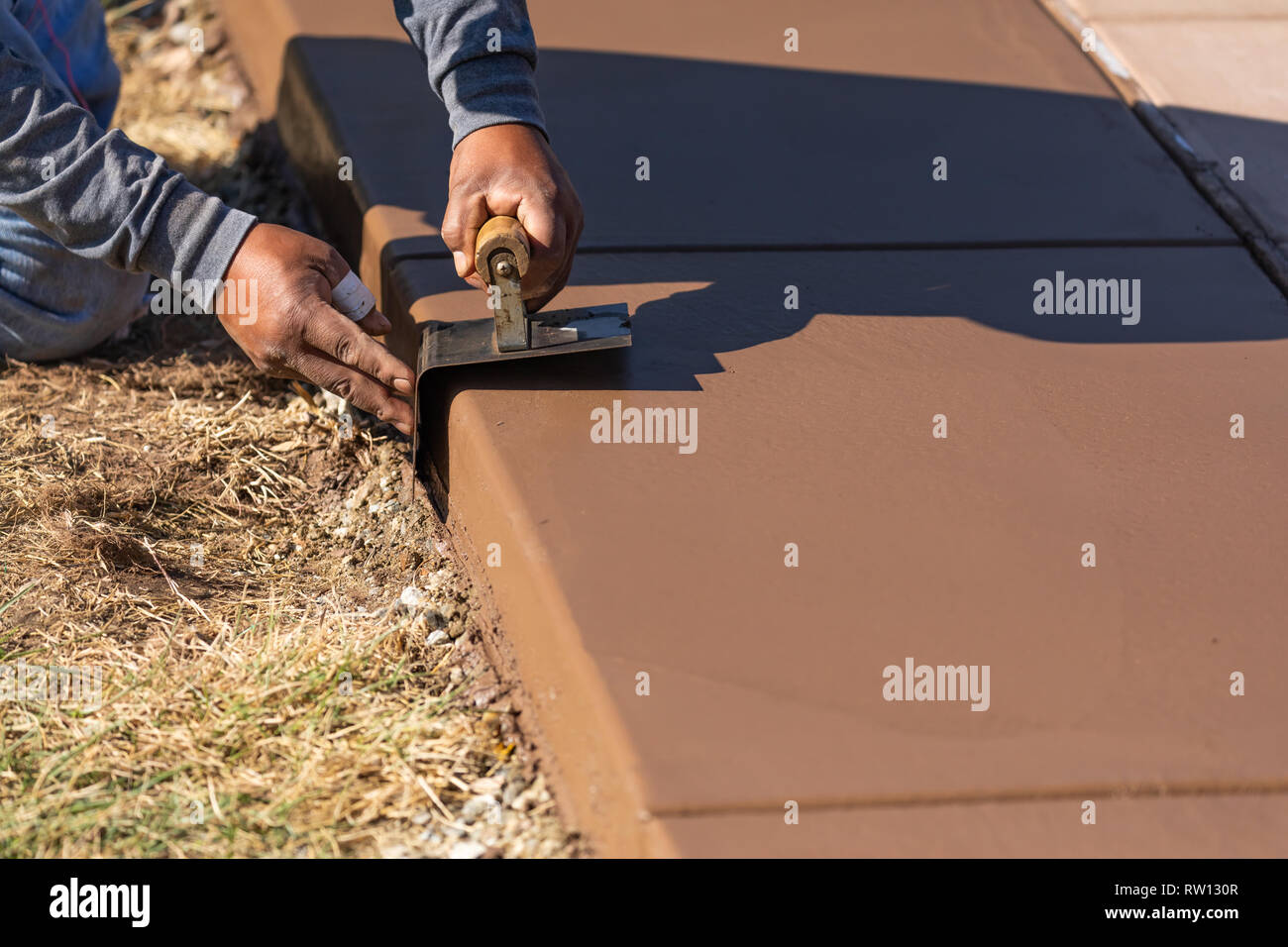 Construction Worker Smoothing Wet Cement With Curb Tool Stock Photo - Alamy