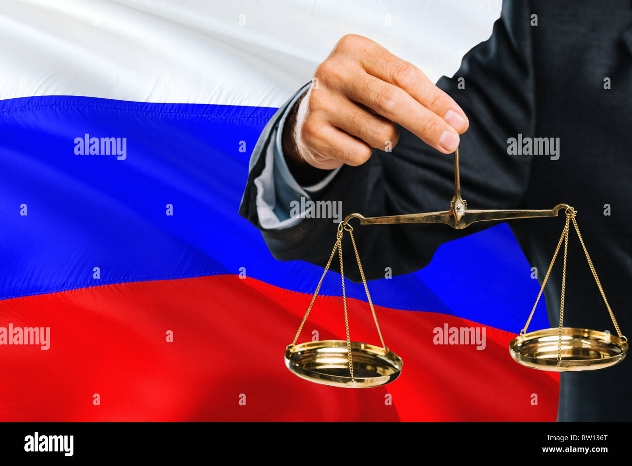 Russian Judge is holding golden scales of justice with Russia waving ...