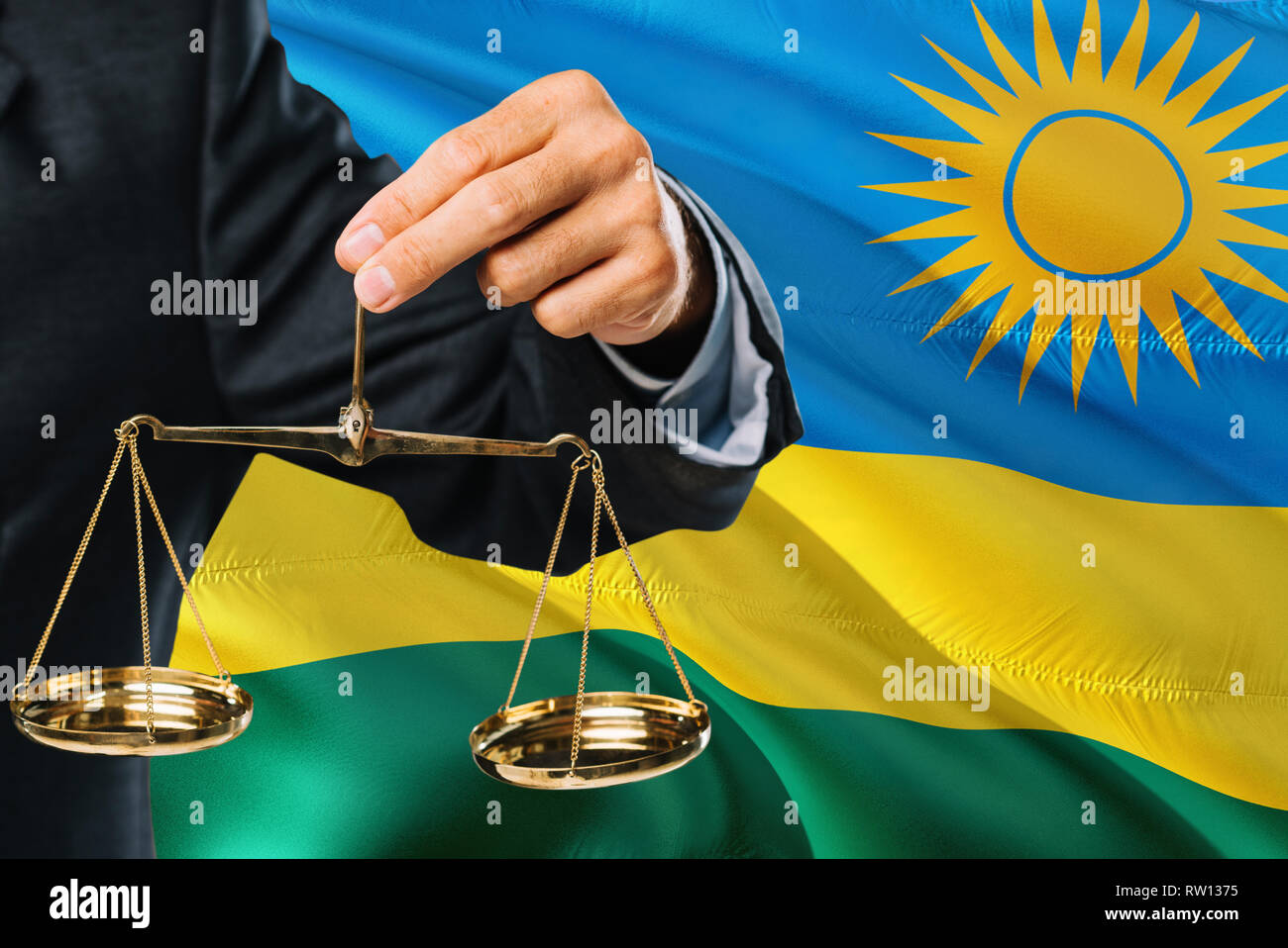 Rwandan Judge is holding golden scales of justice with Rwanda waving ...