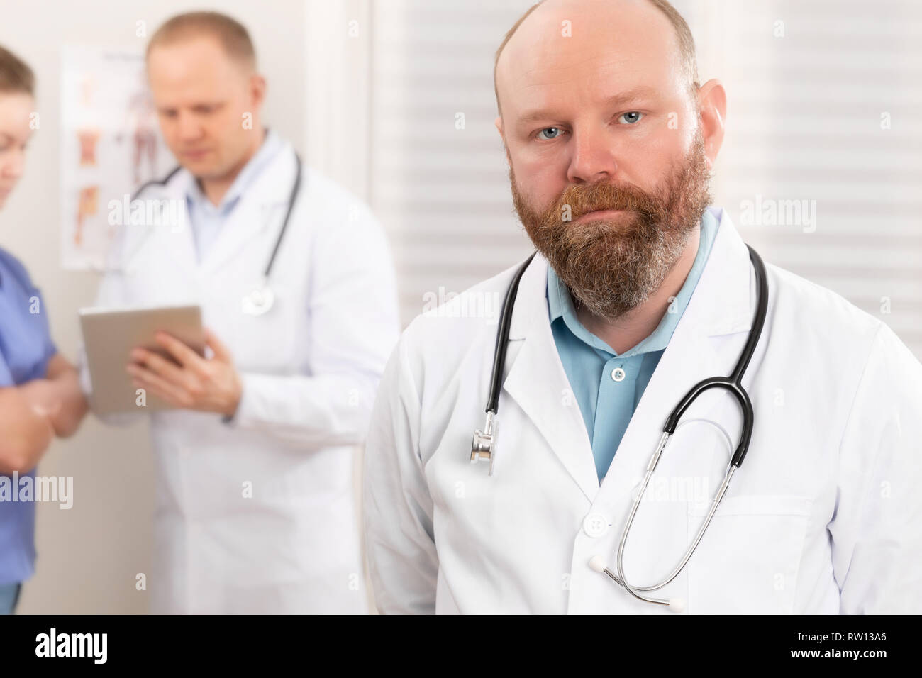Portrait of a confident real doctor standing in front of his health ...