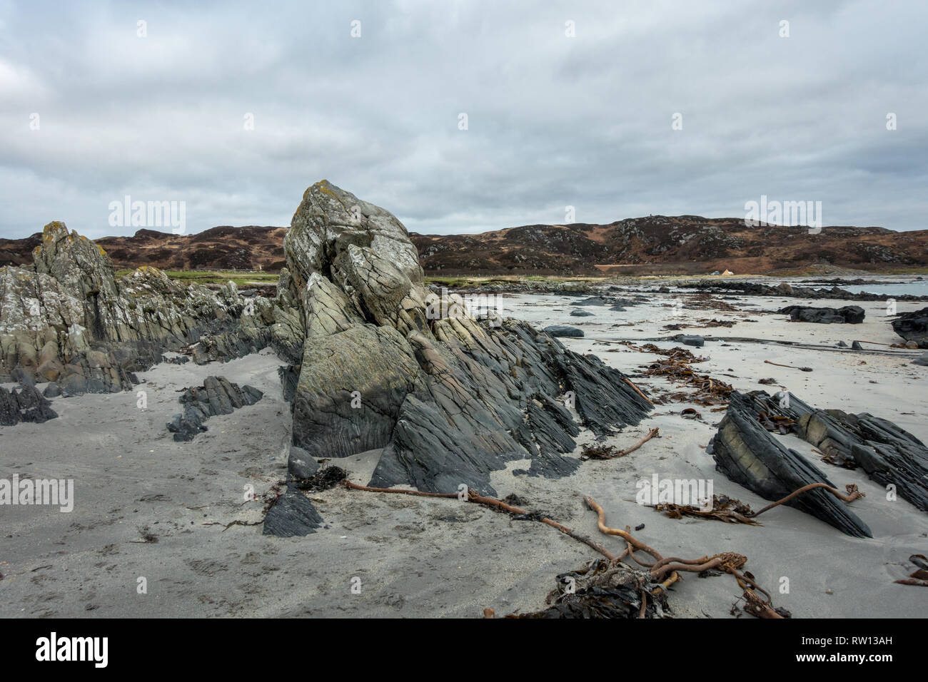 Rock formations on the sands of Uisken Beach in winter on the Isle of ...