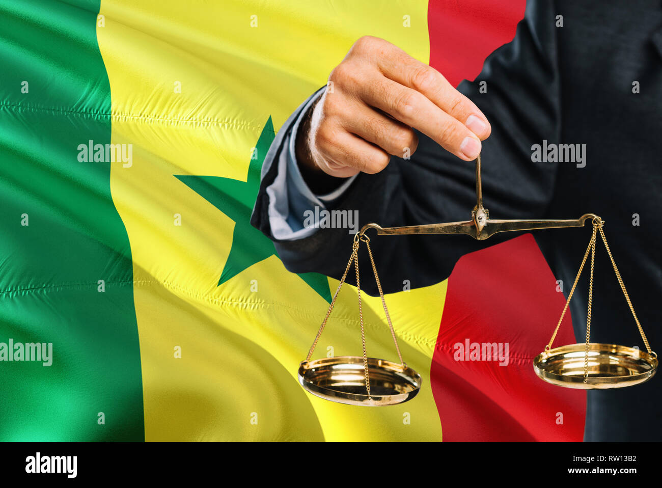 Senegalese Judge is holding golden scales of justice with Senegal ...