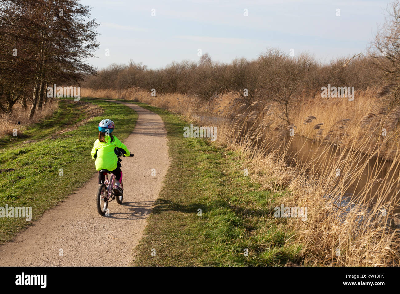 Child cycling UK countryside - a young girl aged 6-7 years cycling in ...