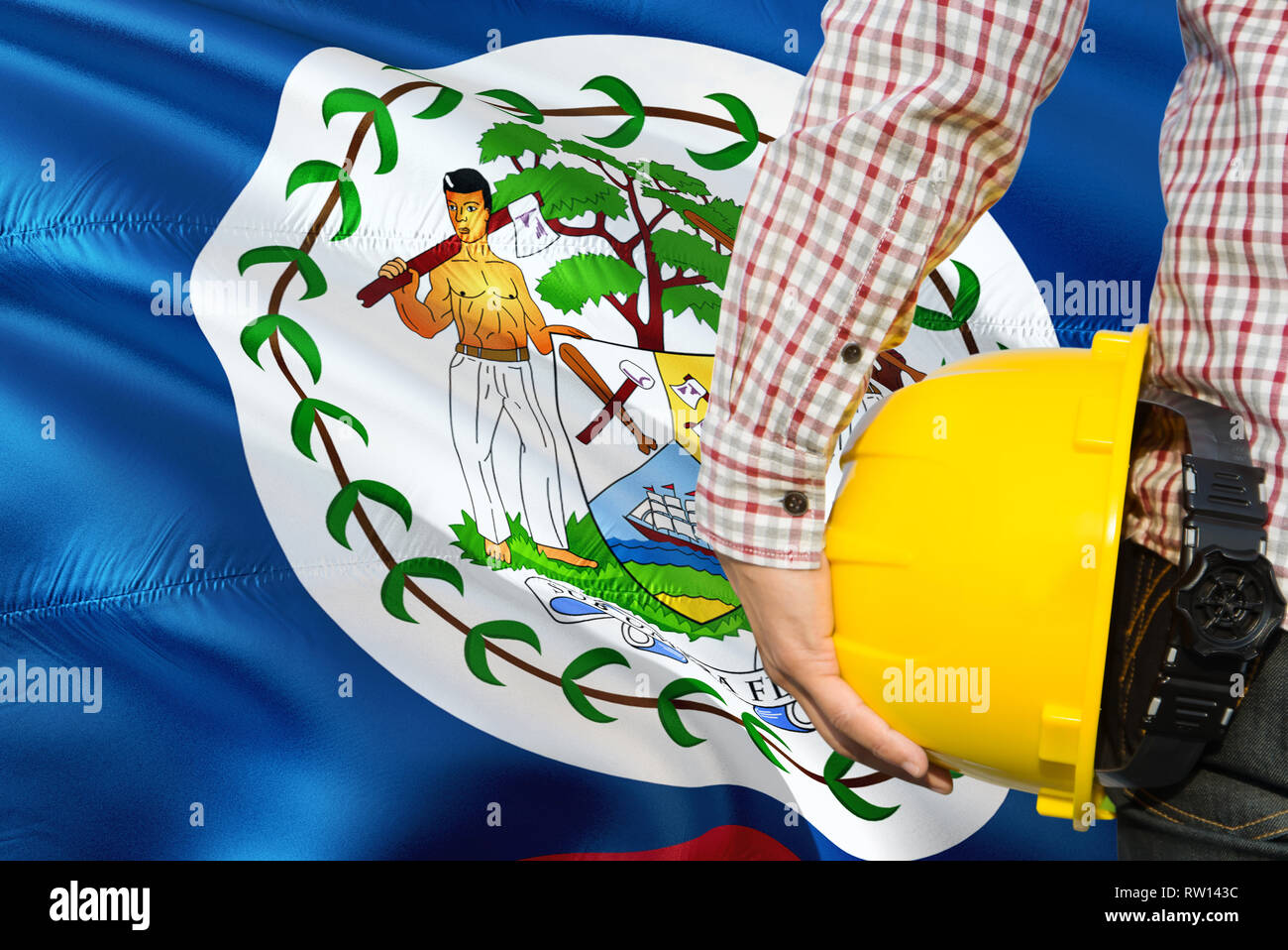 Belizean Engineer is holding yellow safety helmet with waving Belize ...