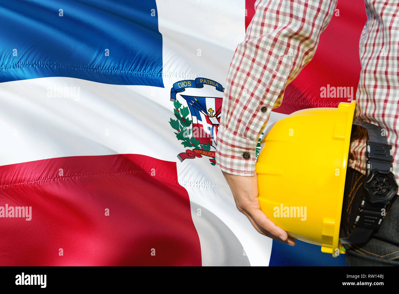 Dominican Engineer is holding yellow safety helmet with waving ...