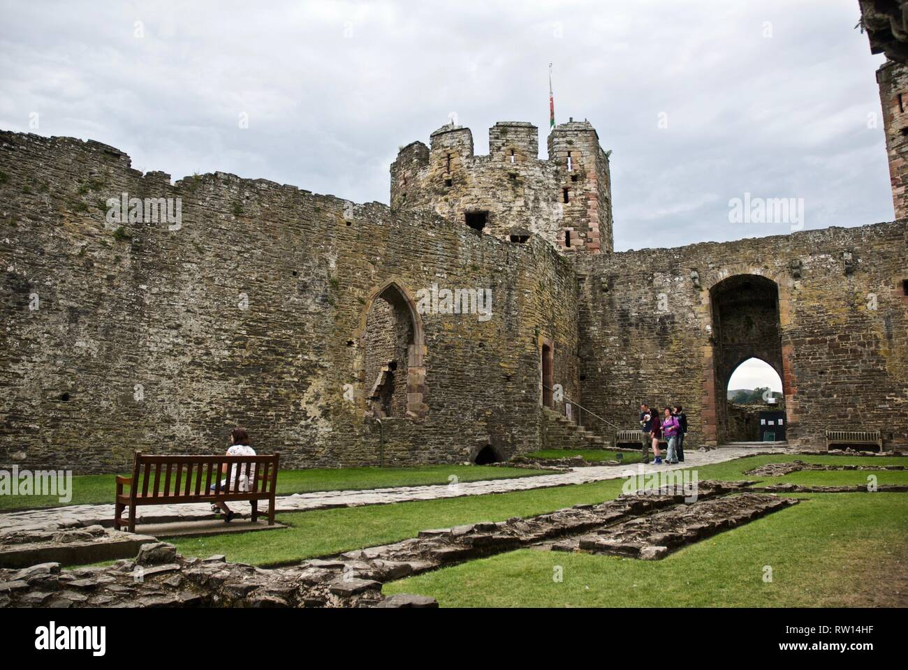 Visitors admire the interior walls and crenellated towers of Conwy ...