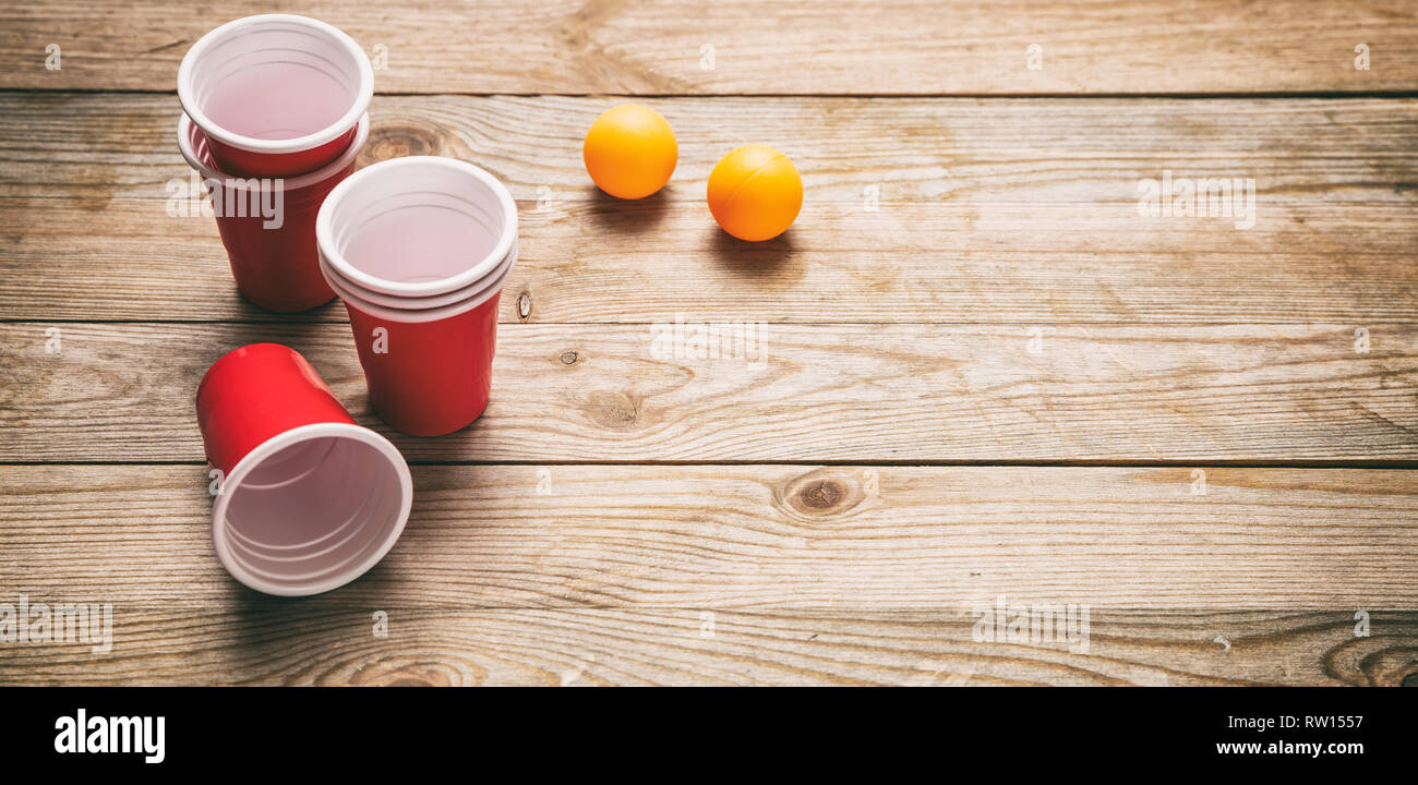 Beer pong, college party game. Plastic red color cups and ping pong ...