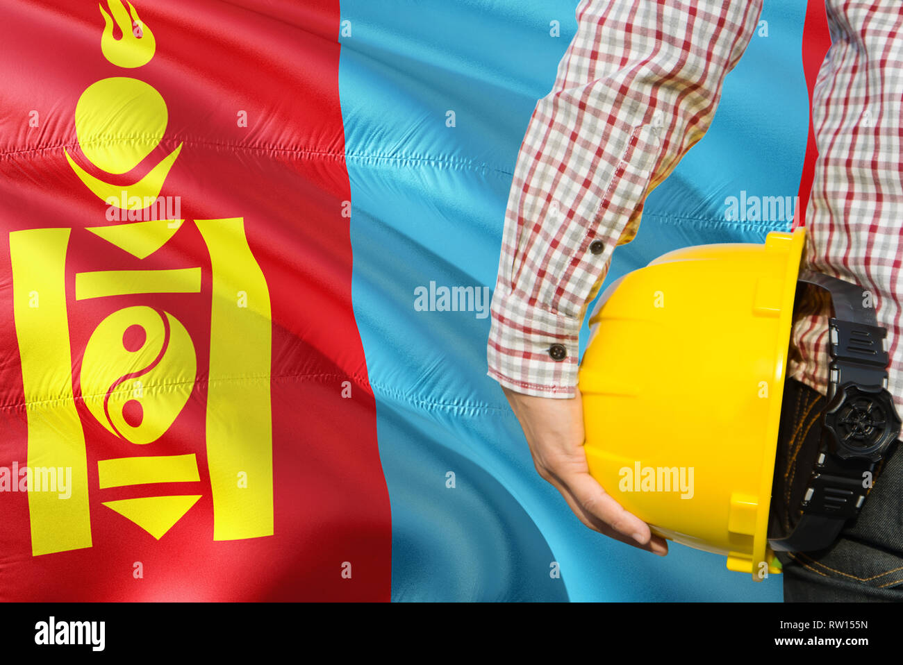 Mongolian Engineer is holding yellow safety helmet with waving Mongolia ...