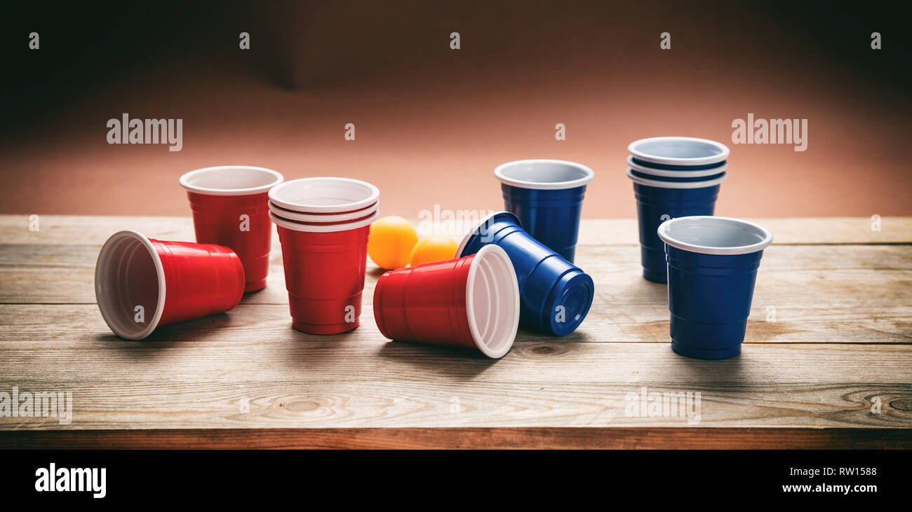 Beer pong, college party game. Plastic red and blue color cups and ping ...