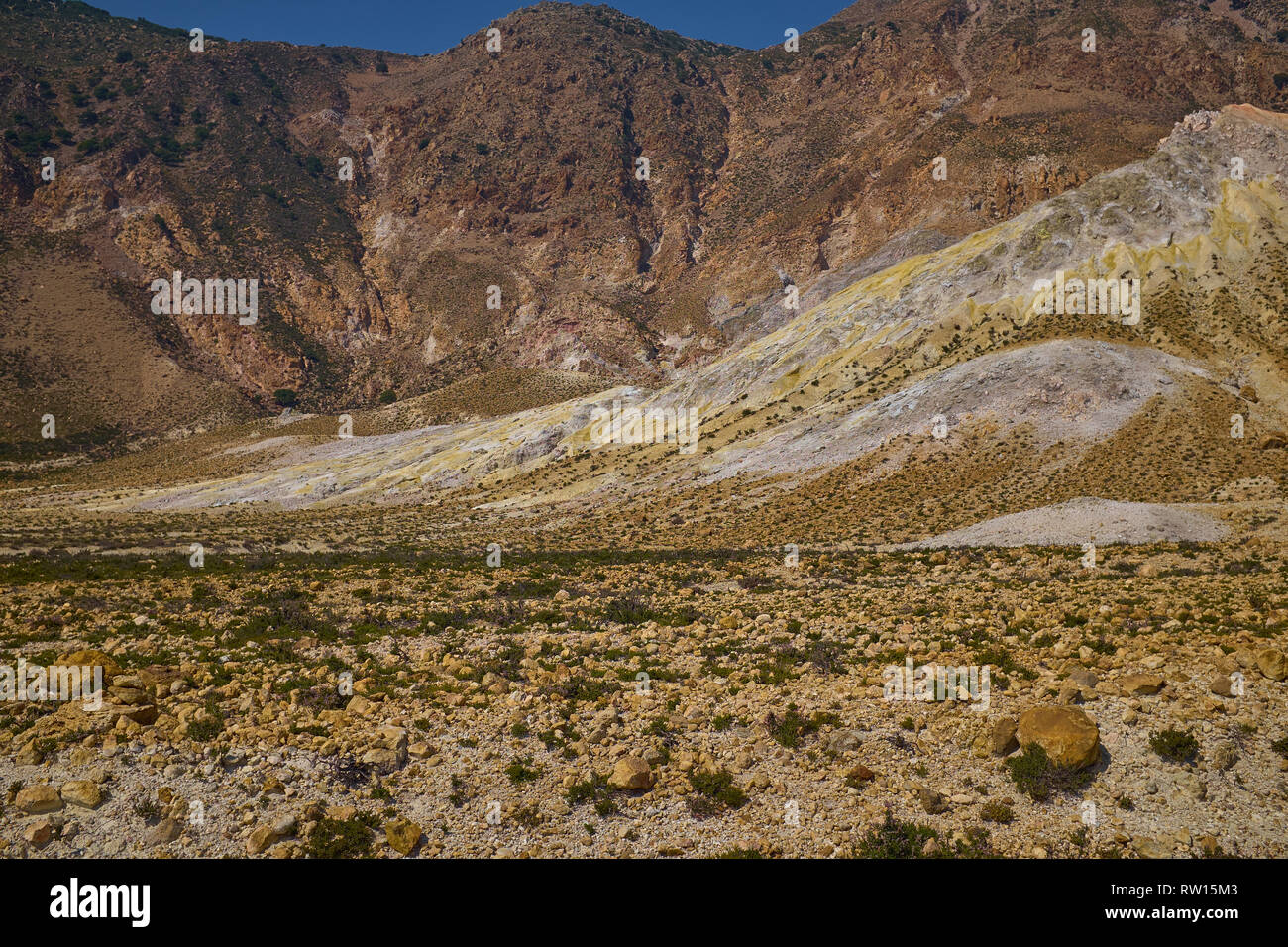 A lot of sulfur rocks under blue sky, geothermal activity, yellow ...