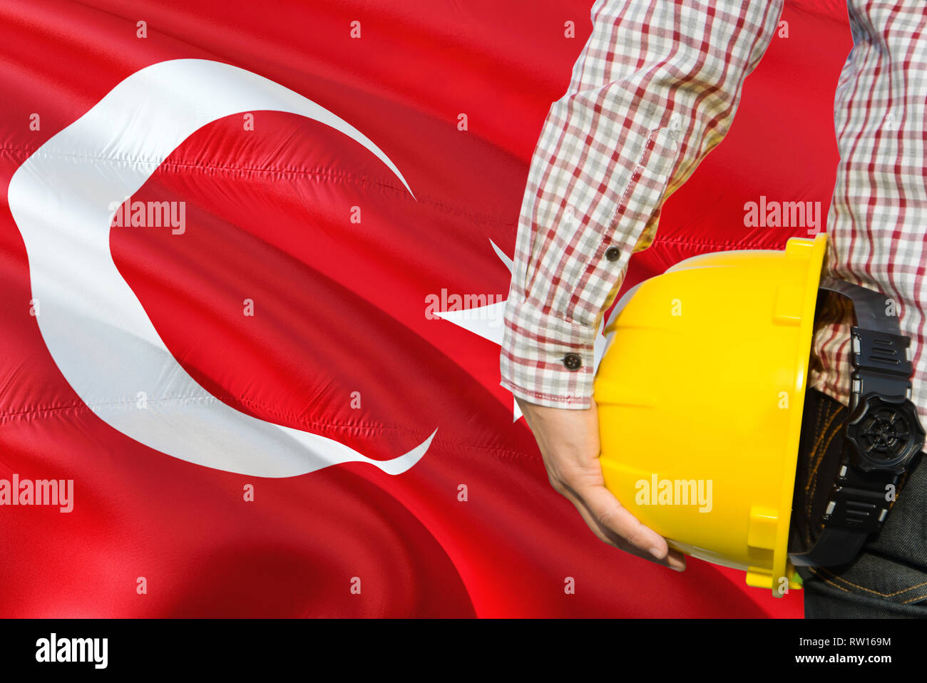 Turkish Engineer is holding yellow safety helmet with waving Turkey ...