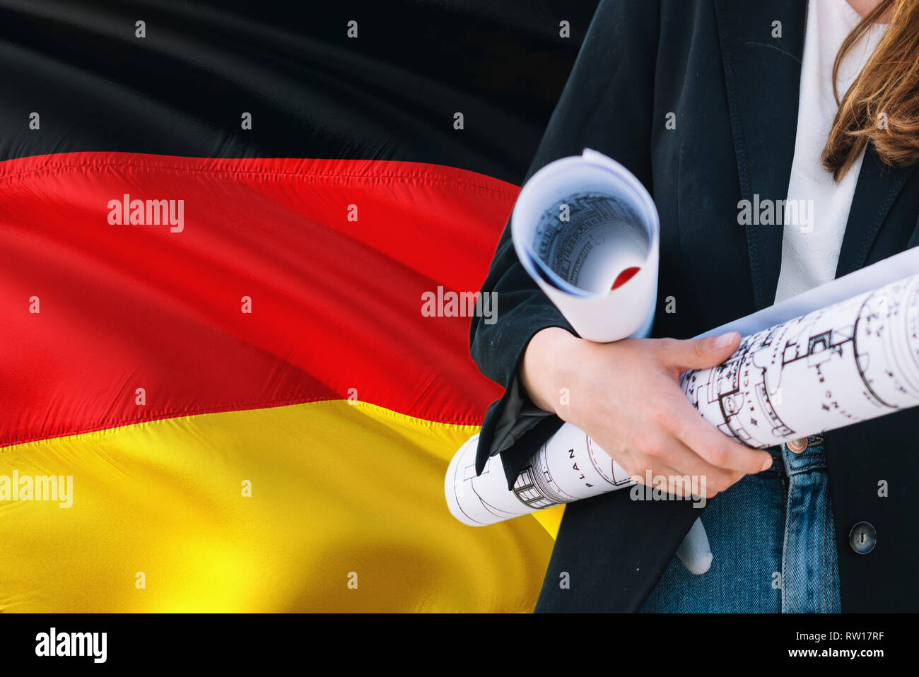German Architect woman holding blueprint against Germany waving flag ...