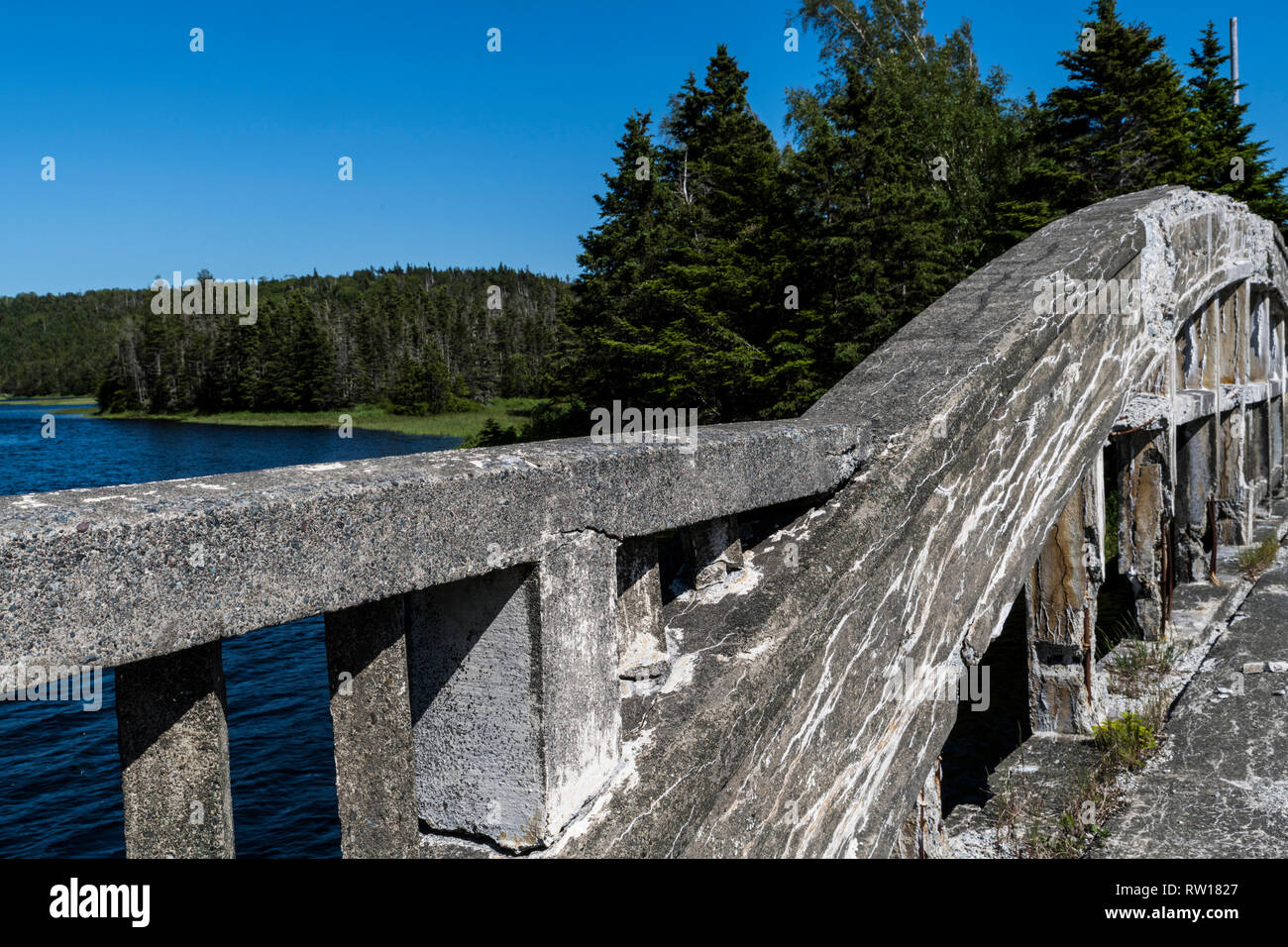 Built in 1929, decaying old bridge showing rusting rebar, crosses over ...