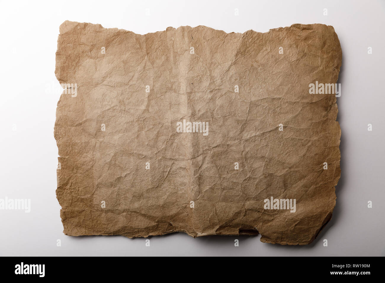 top view of old paper sheet lying on white background Stock Photo - Alamy