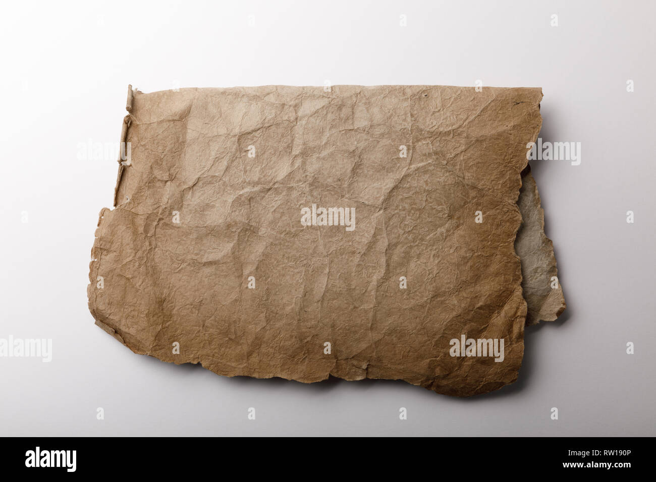 top view of old parchment paper lying on white background Stock Photo ...