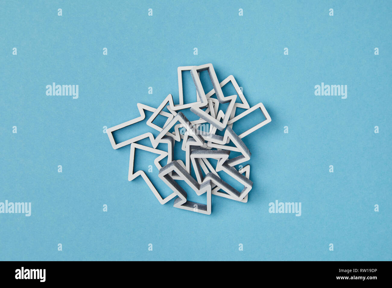top view of mixed white arrows on blue background Stock Photo - Alamy
