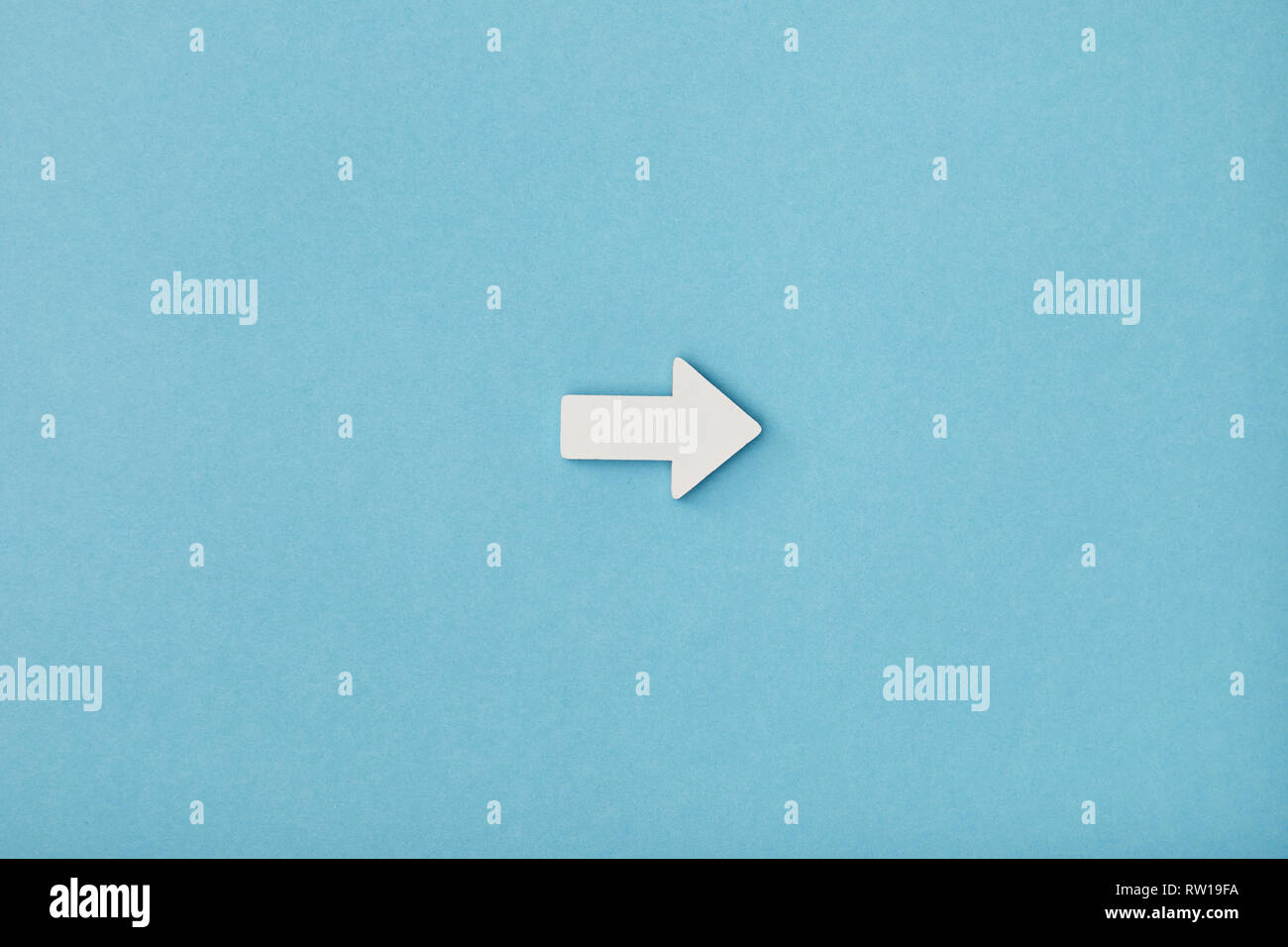 top view of white horizontal pointer on blue background Stock Photo - Alamy