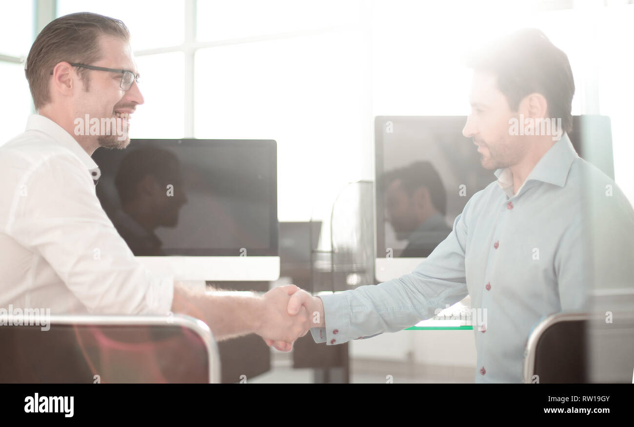 handshake colleagues in the workplace Stock Photo - Alamy