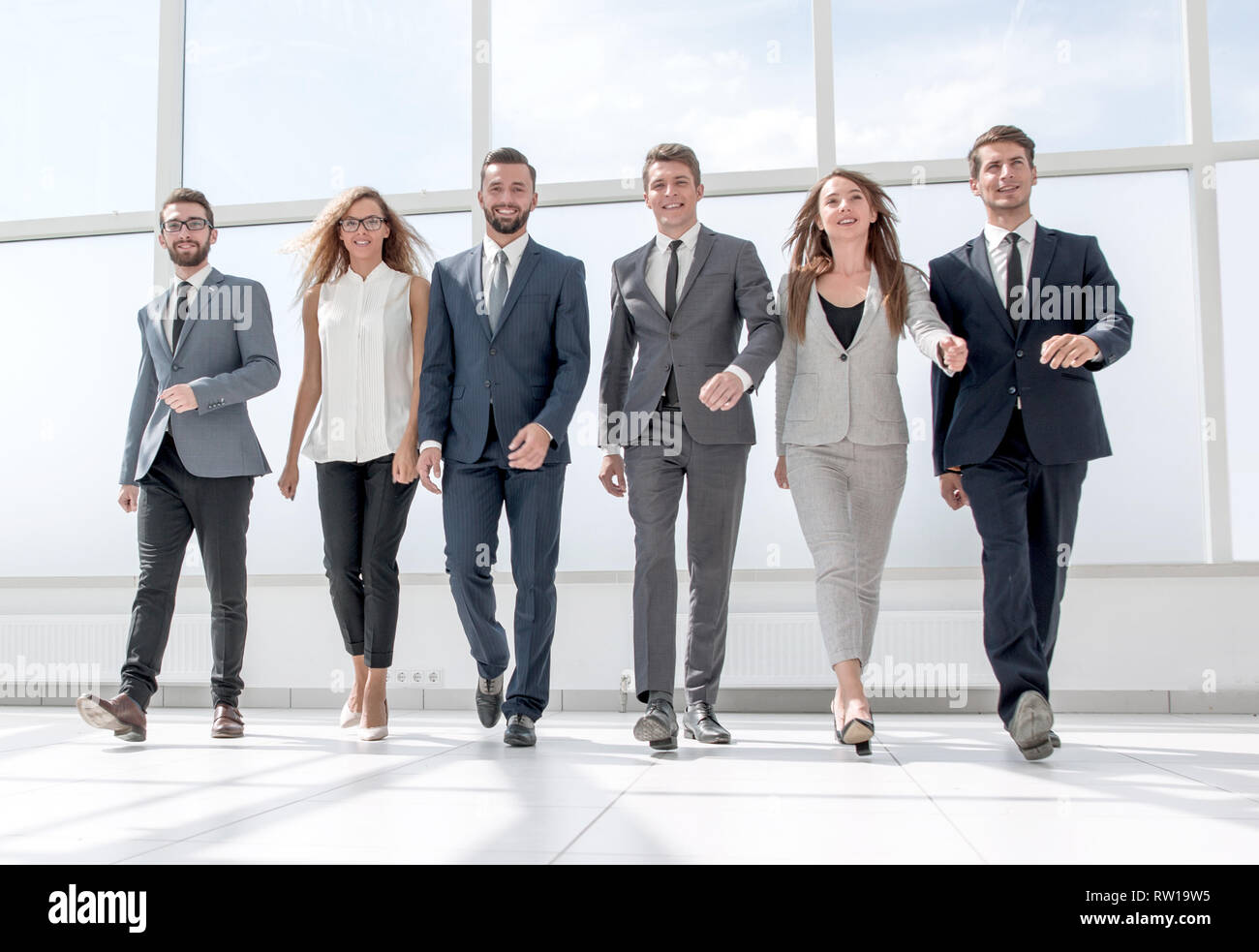 successful business walking in the office lobby Stock Photo - Alamy