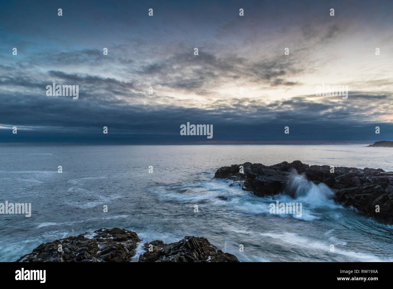 Sunset on the ocean in St. Bride's, Newfoundland, Canada, red sky and a ...