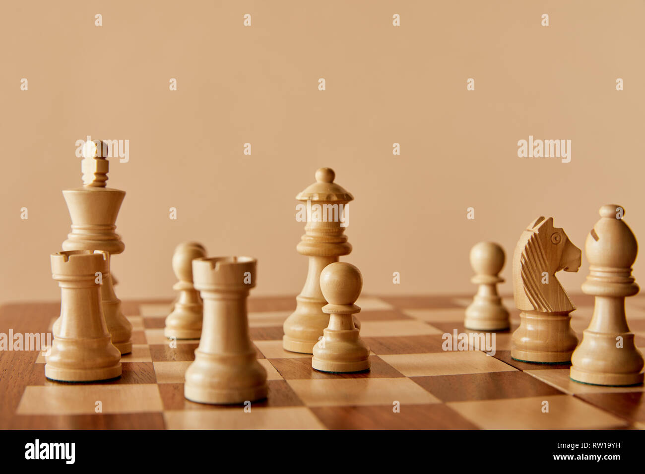 wooden chess on chess board and beige background Stock Photo - Alamy