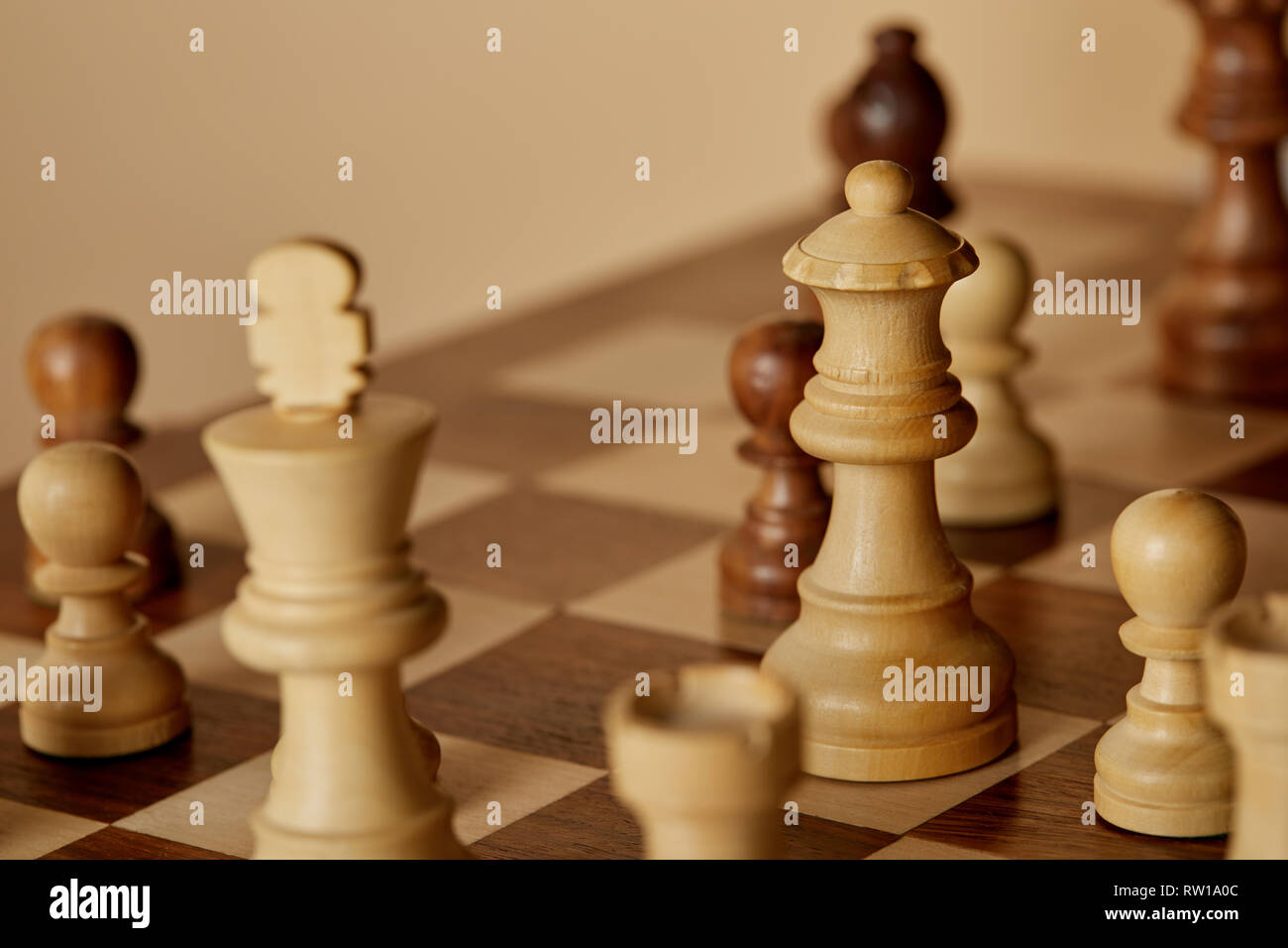 selective focus of wooden chess pieces on chess board and beige ...