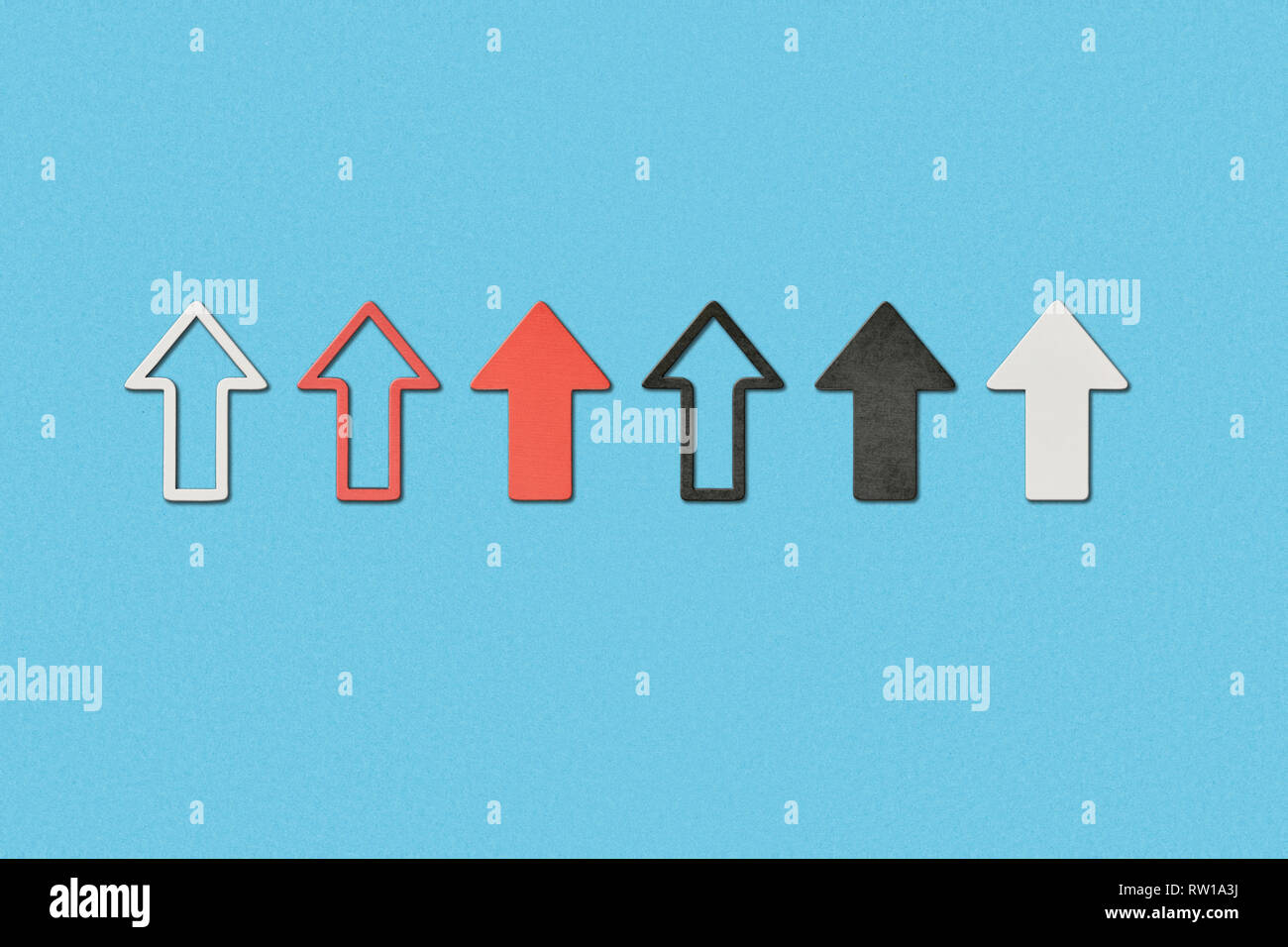 top view of vertical red, white and black pointers on blue background ...