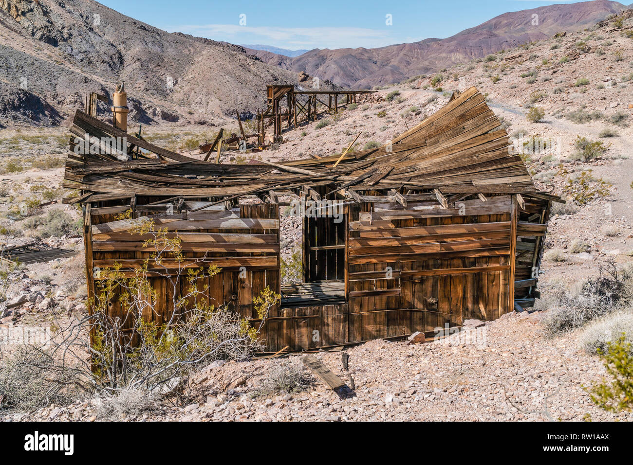 A wooden house with a collapsed swayback roof at the Inyo Mine ruins in ...