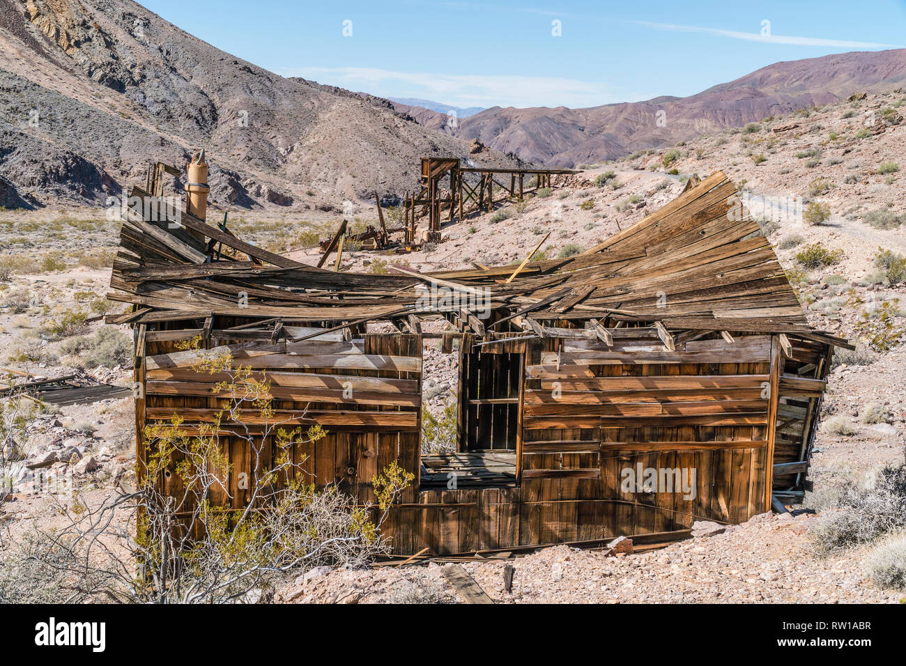 A wooden house with a collapsed swayback roof at the Inyo Mine ruins in ...