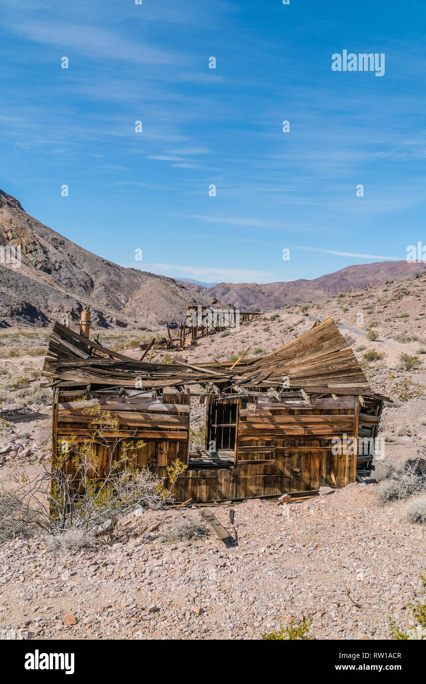 A wooden house with a collapsed swayback roof at the Inyo Mine ruins in ...
