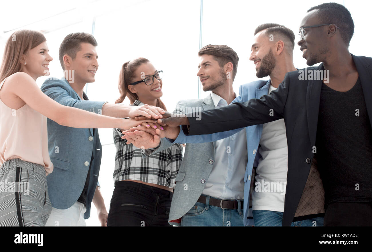 Group of business people piling up their hands together in the ...