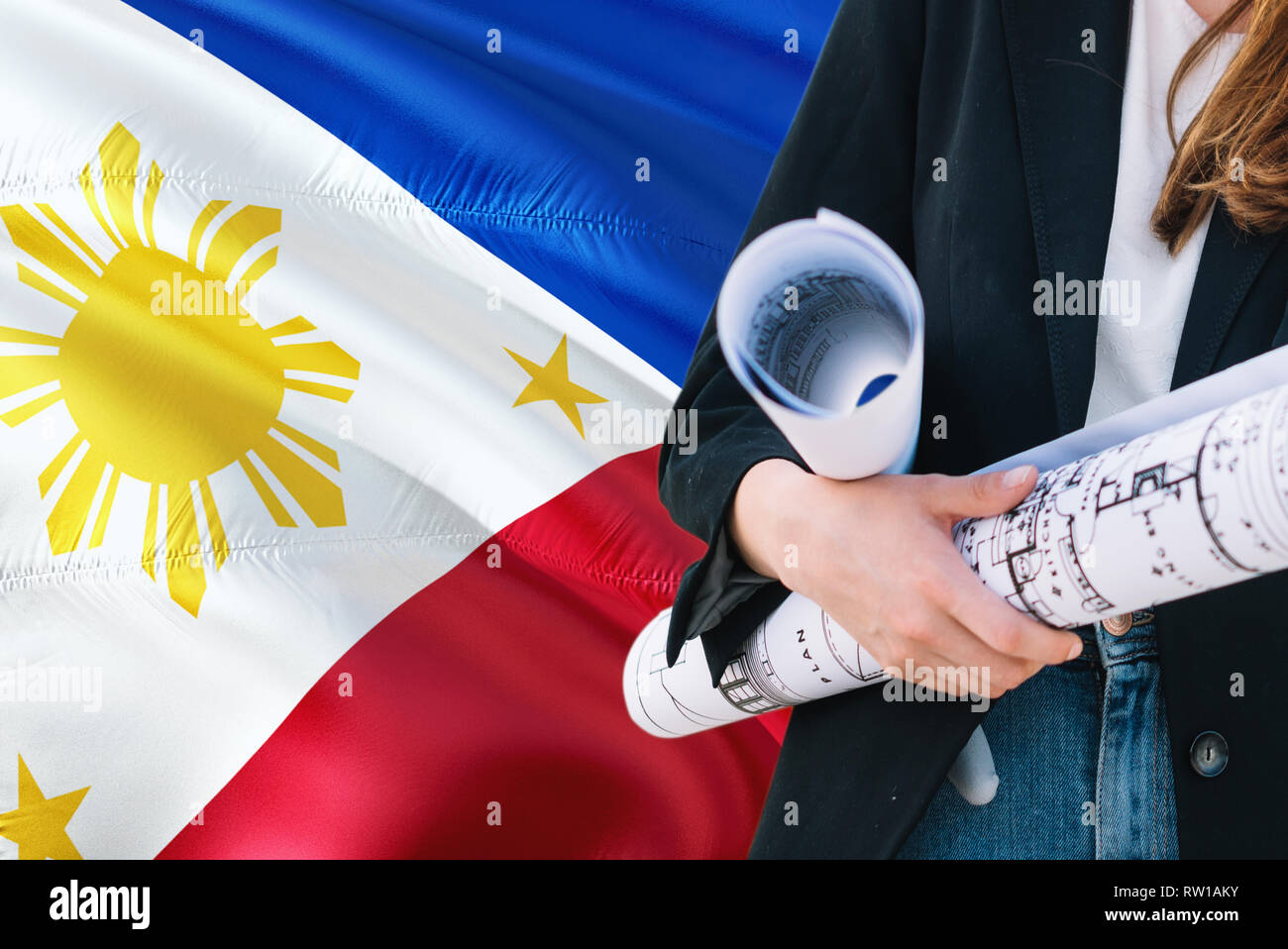 Filipino Architect woman holding blueprint against Philippines waving ...