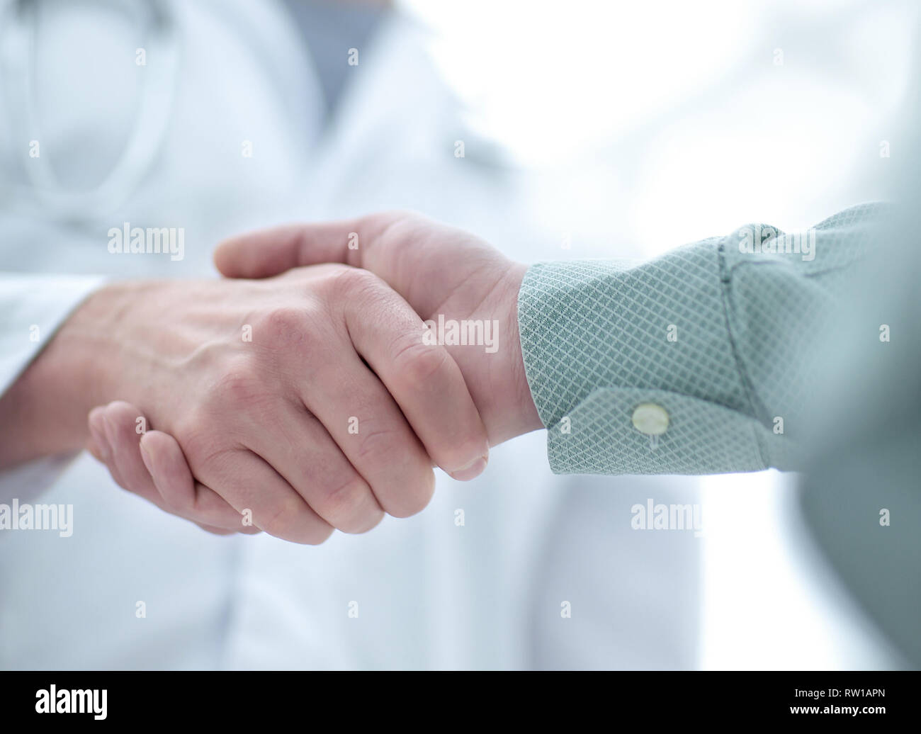 closeup.handshake between doctor and patient Stock Photo - Alamy