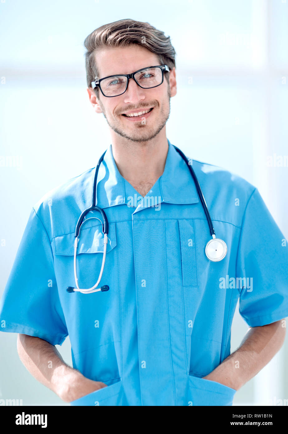 surgeon man in blue uniform standing in the hall Stock Photo - Alamy