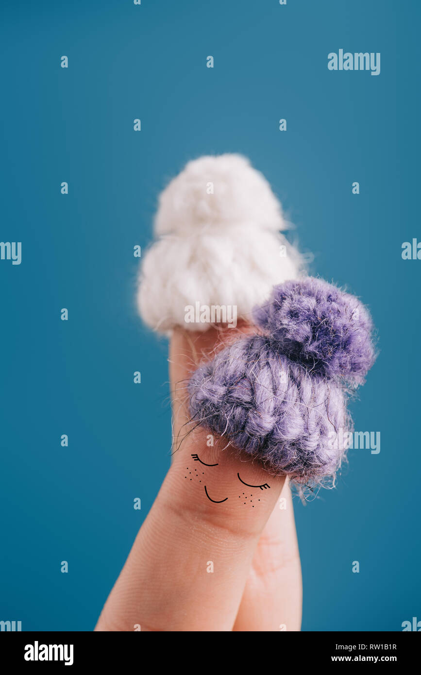 cropped view of fingers as dreamy couple with closed eyes in knitted ...