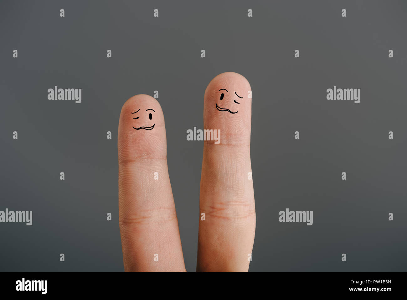 cropped view of confused human fingers isolated on grey Stock Photo - Alamy